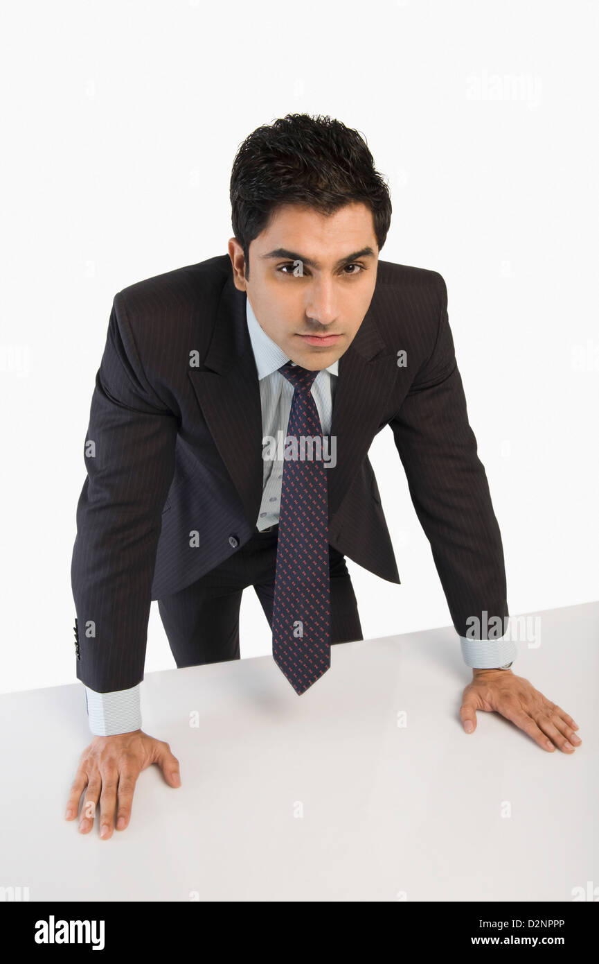 Portrait of a businessman standing at a conference table Stock Photo ...