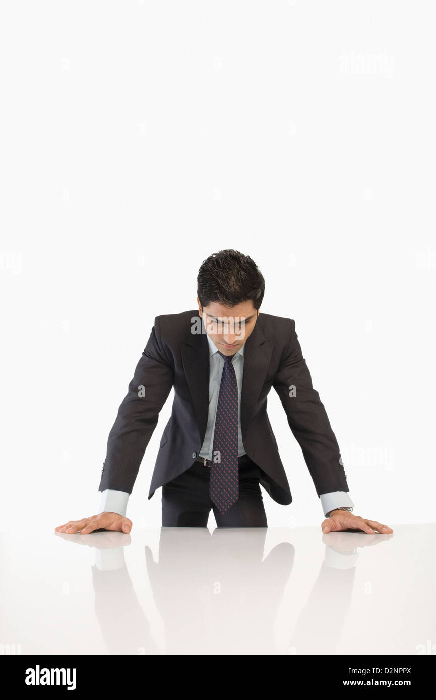 Businessman standing at a conference table Stock Photo - Alamy