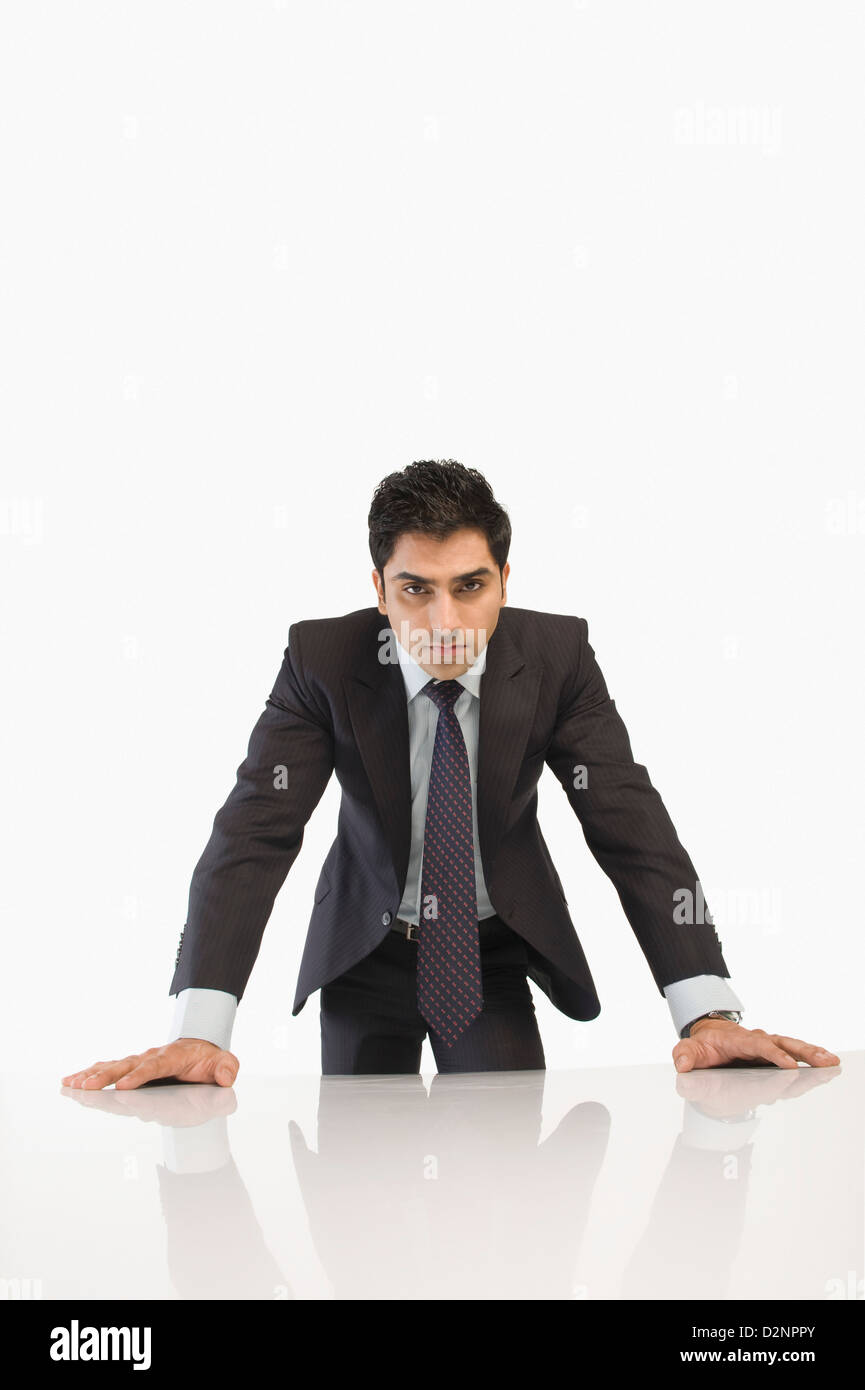 Portrait of a businessman standing at a conference table Stock Photo ...