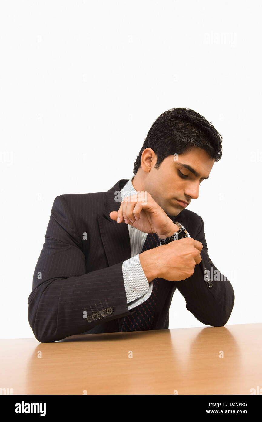 Businessman checking the time Stock Photo - Alamy