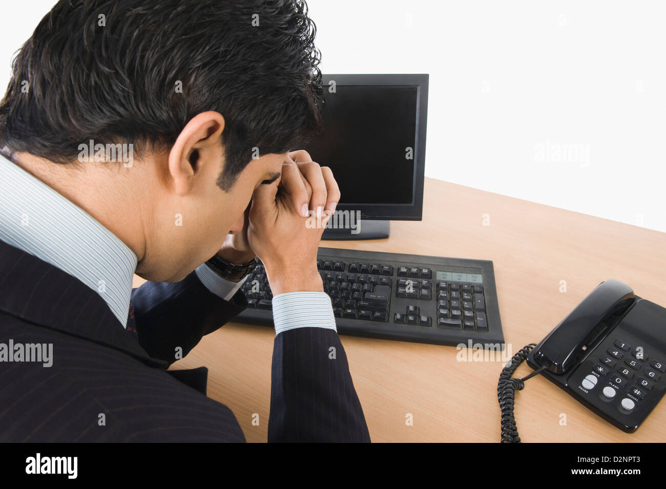 Businessman praying in front of a computer Stock Photo - Alamy