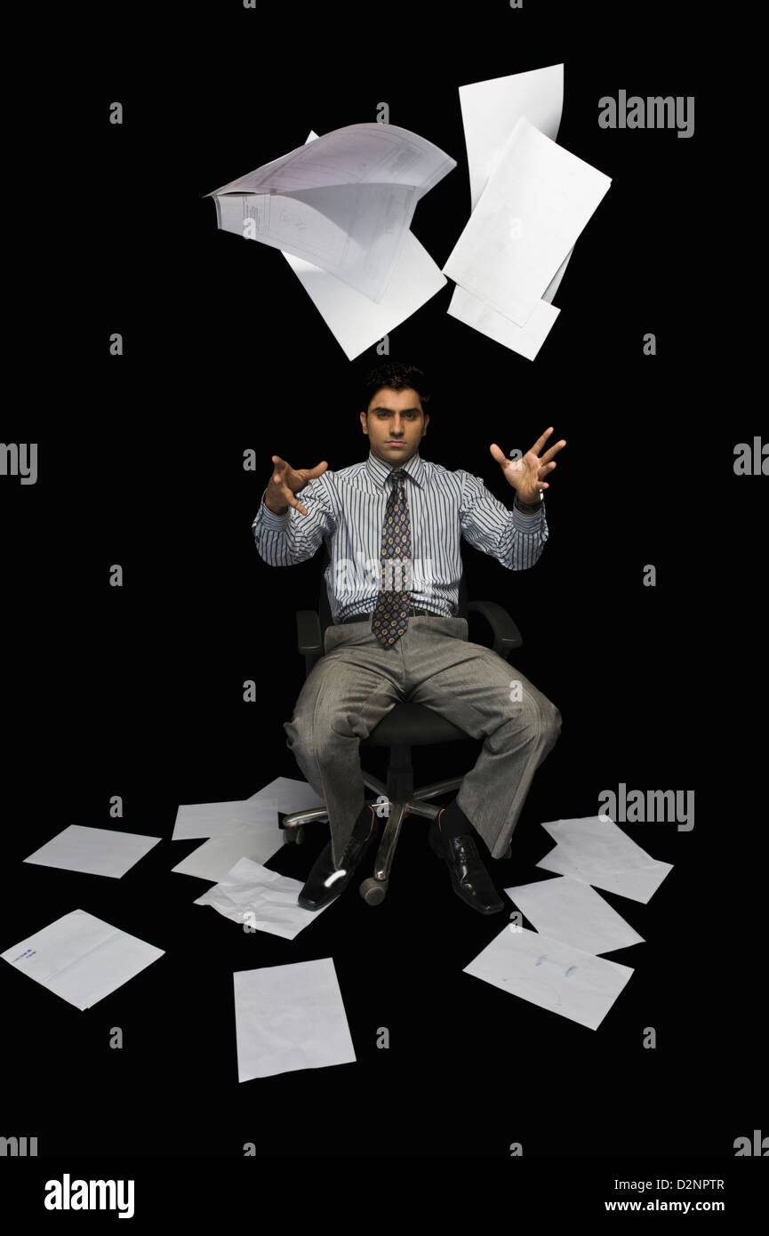 Businessman throwing papers in the air Stock Photo - Alamy