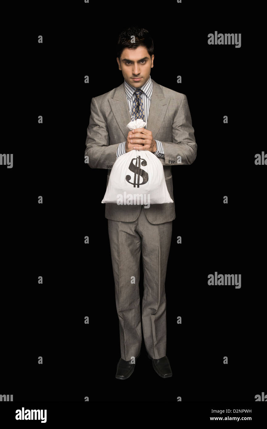 Businessman holding money bag hi-res stock photography and images - Alamy
