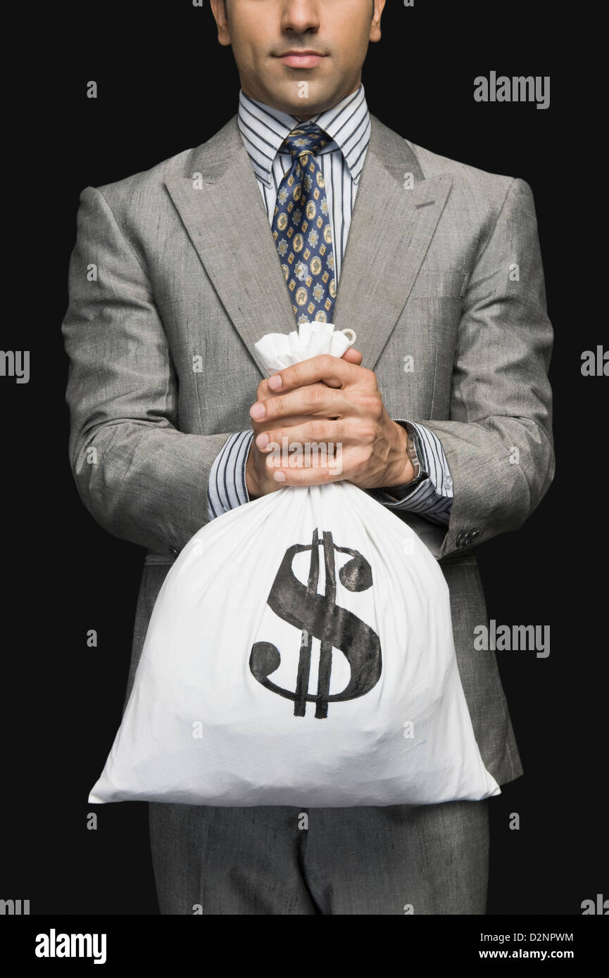 Businessman holding a money bag Stock Photo - Alamy