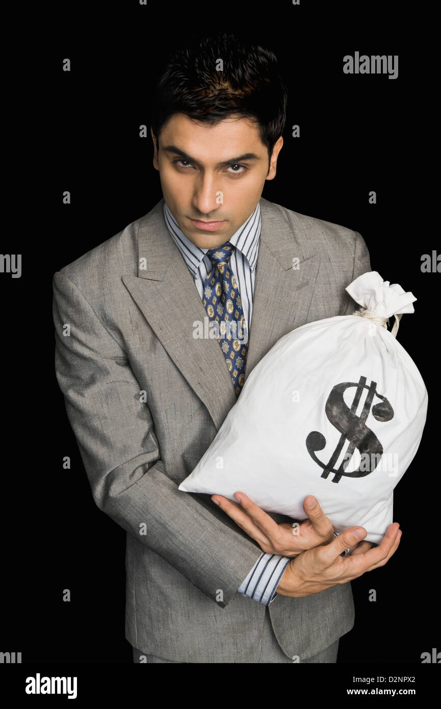Businessman holding a money bag Stock Photo - Alamy