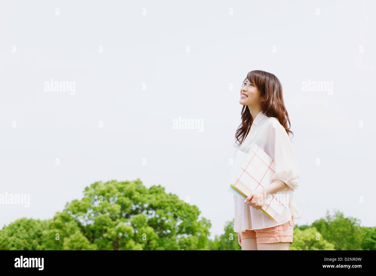 Young woman looking up Stock Photo - Alamy