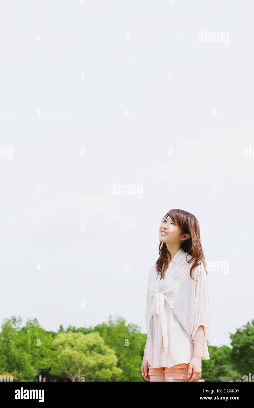 Young woman looking up Stock Photo - Alamy