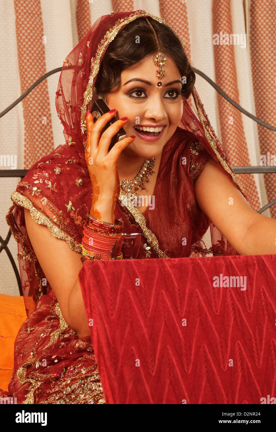Bride talking on a mobile phone and holding a jewelry box Stock Photo ...