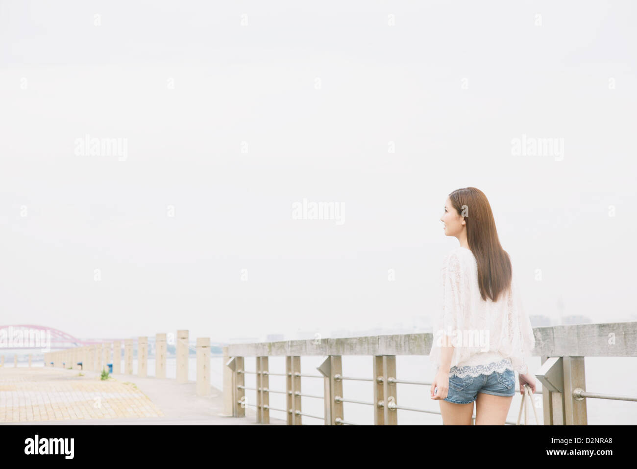 Young woman walking away Stock Photo - Alamy