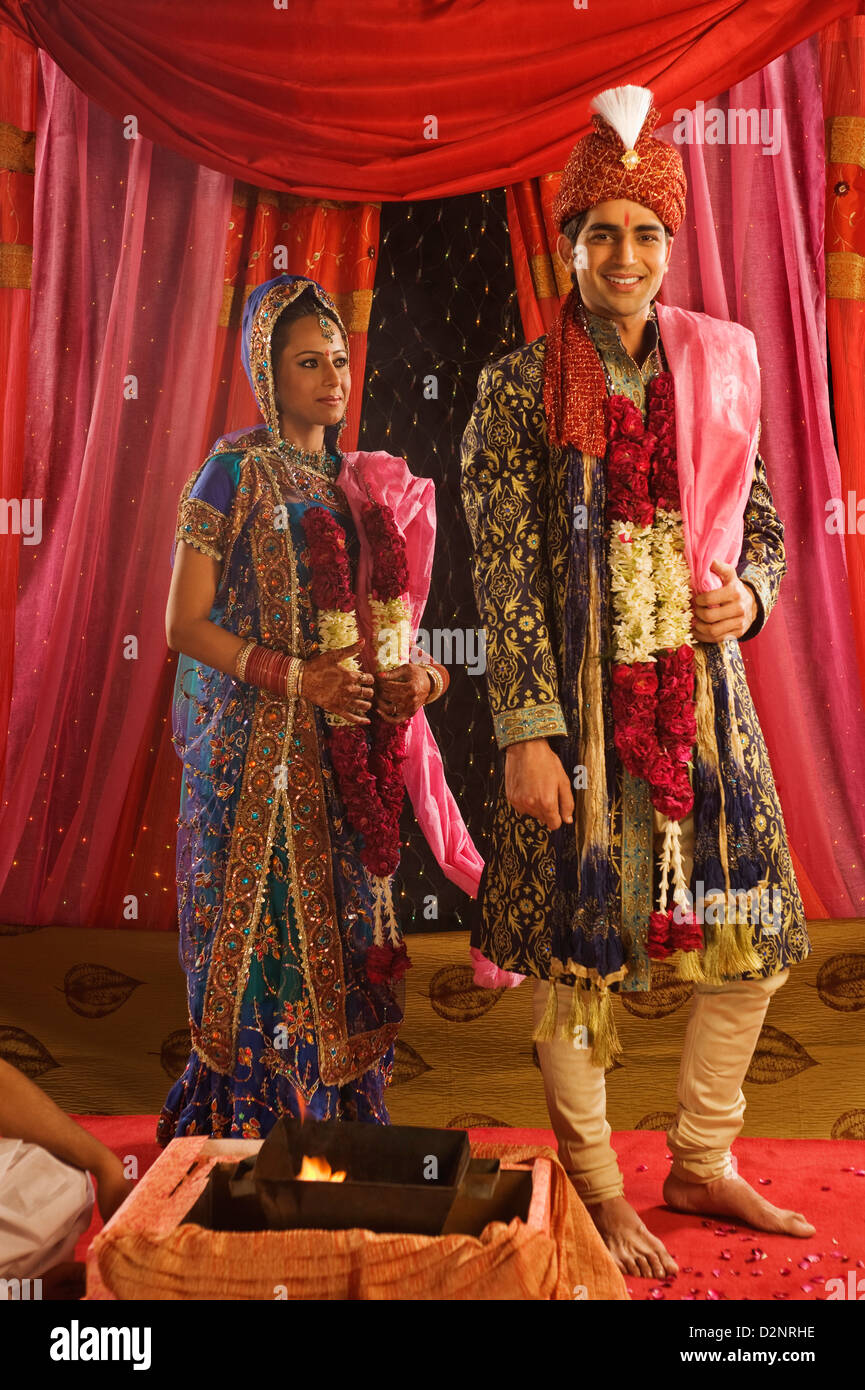 Couple performing Saptapadi ceremony in wedding mandap Stock Photo - Alamy