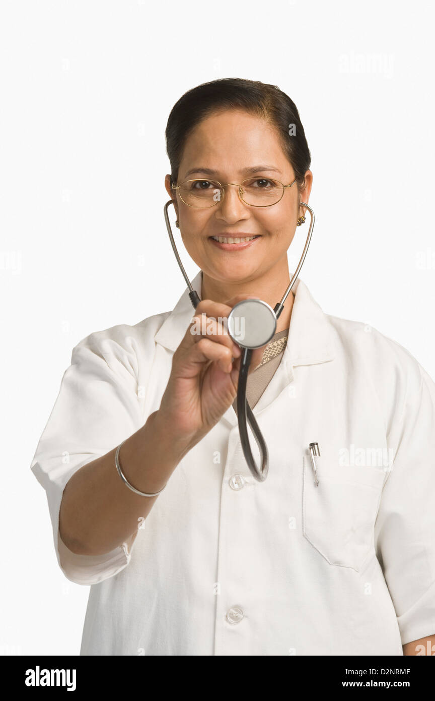 Female doctor examining with a stethoscope Stock Photo - Alamy