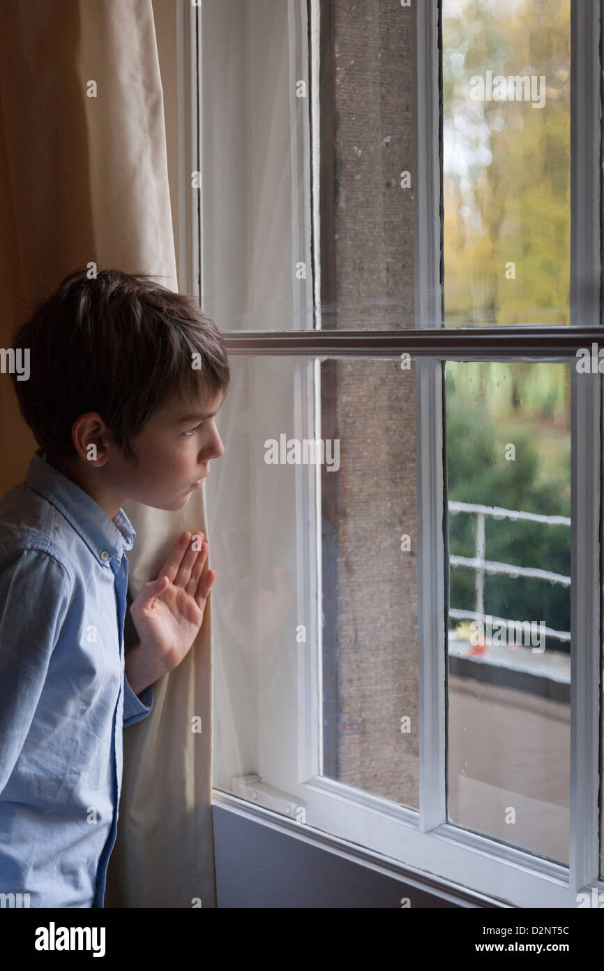 Boy by the window Stock Photo - Alamy
