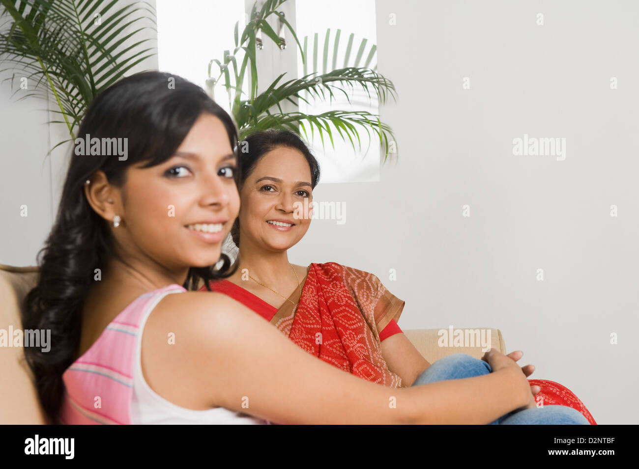 Portrait of a woman sitting with her mother and smiling Stock Photo - Alamy