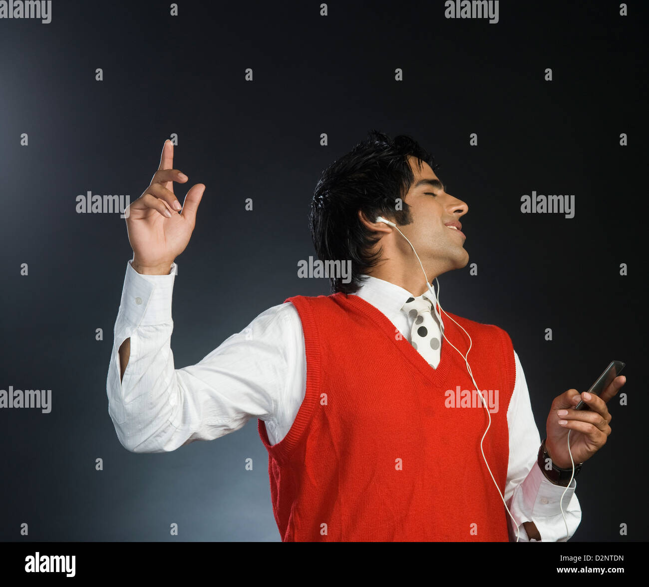 Businessman listening to an MP3 player and dancing Stock Photo - Alamy