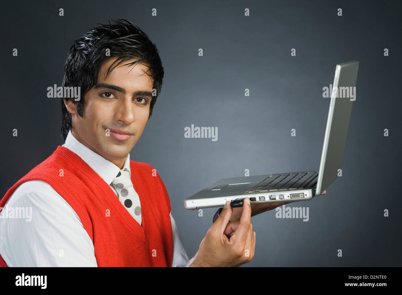 Businessman plugging in a USB device into a laptop Stock Photo - Alamy