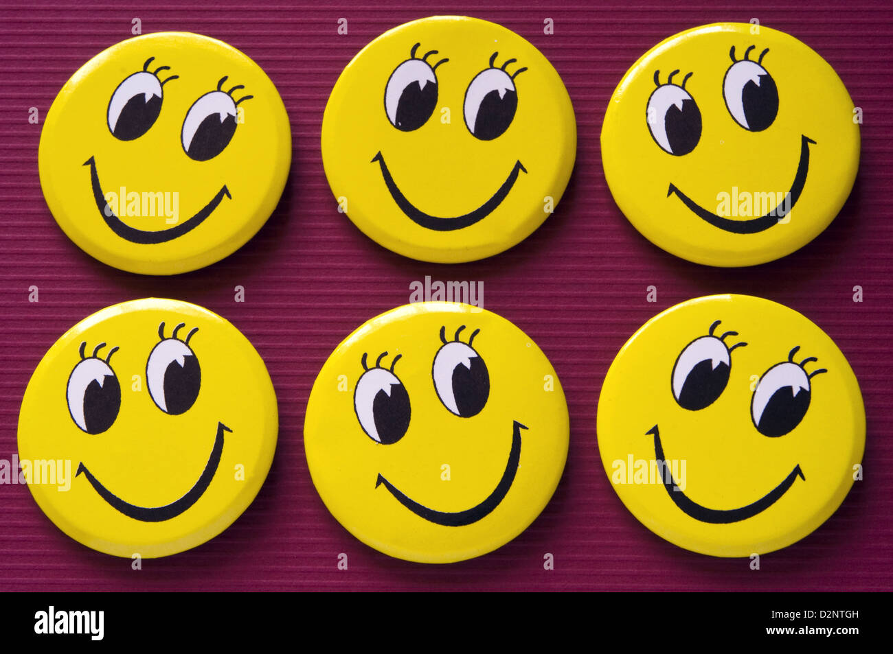 smile badges in studio setting Stock Photo - Alamy