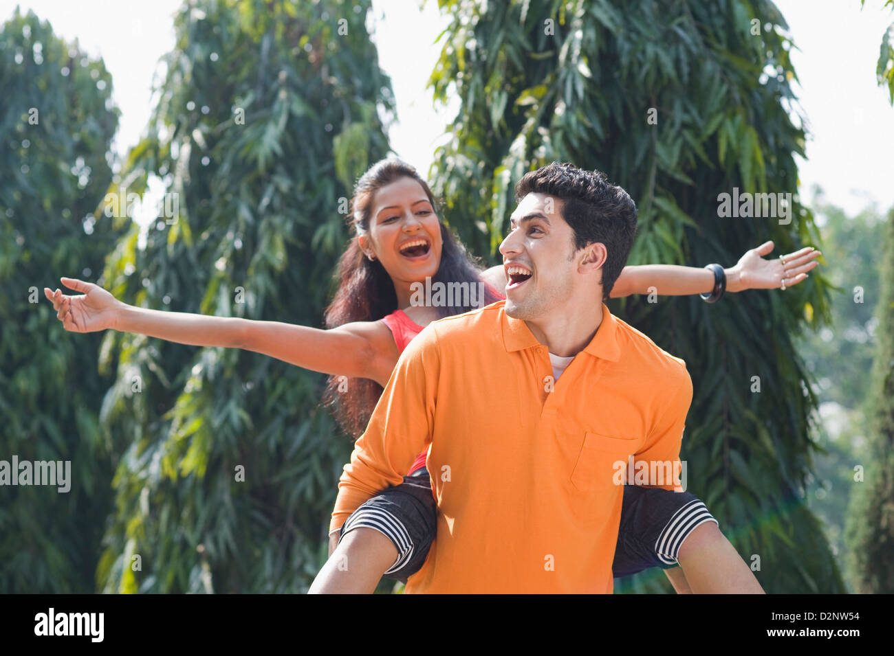 Woman riding piggyback on a man and smiling Stock Photo - Alamy