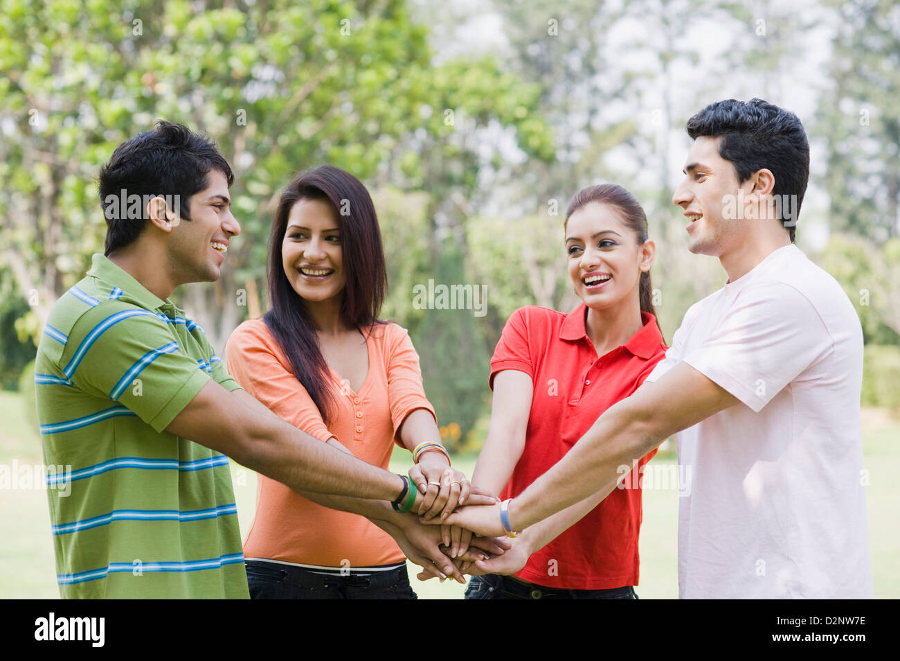 Friends joining hands together Stock Photo - Alamy