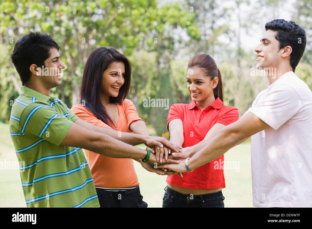 Friends joining hands together Stock Photo - Alamy