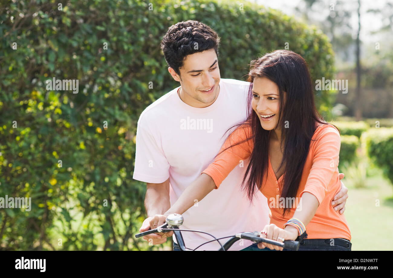 Man supporting a woman on a bicycle Stock Photo - Alamy
