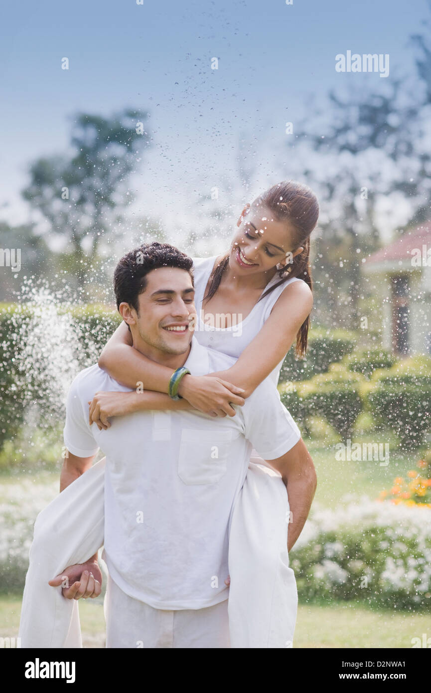 Woman riding piggyback on a man Stock Photo - Alamy