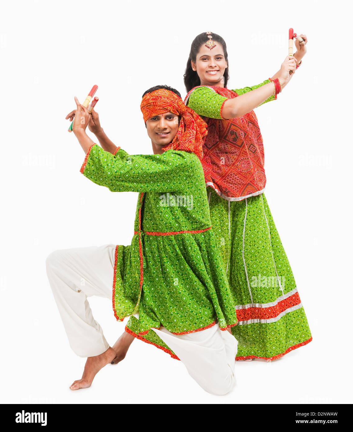Couple performing dandiya Stock Photo - Alamy