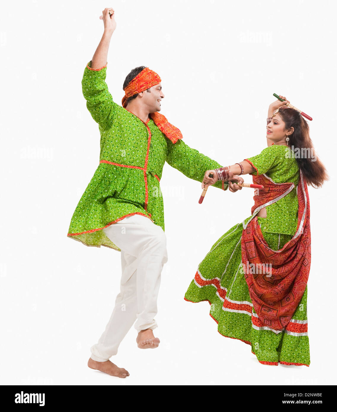 Couple performing dandiya Stock Photo - Alamy