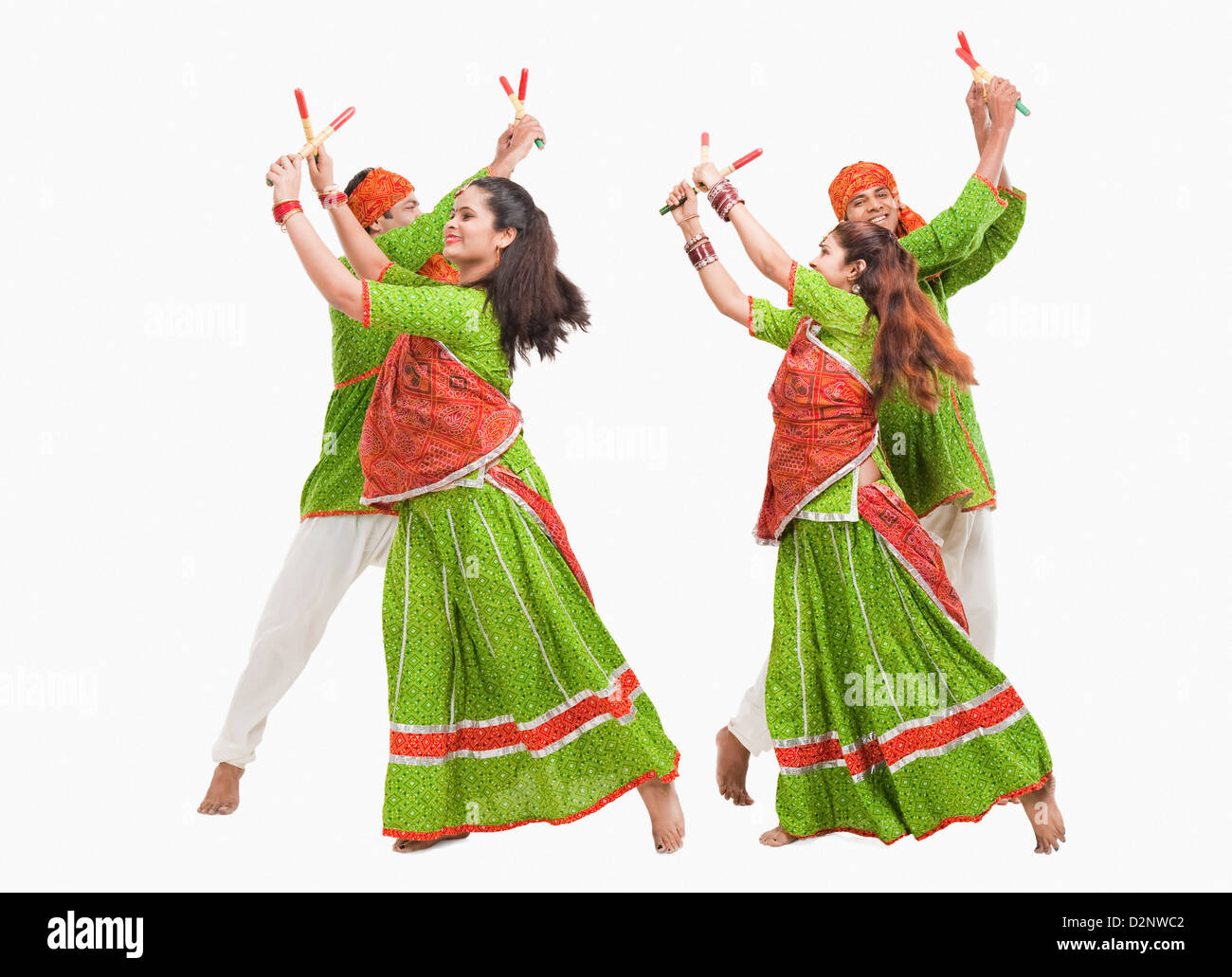 Couples performing dandiya Stock Photo - Alamy