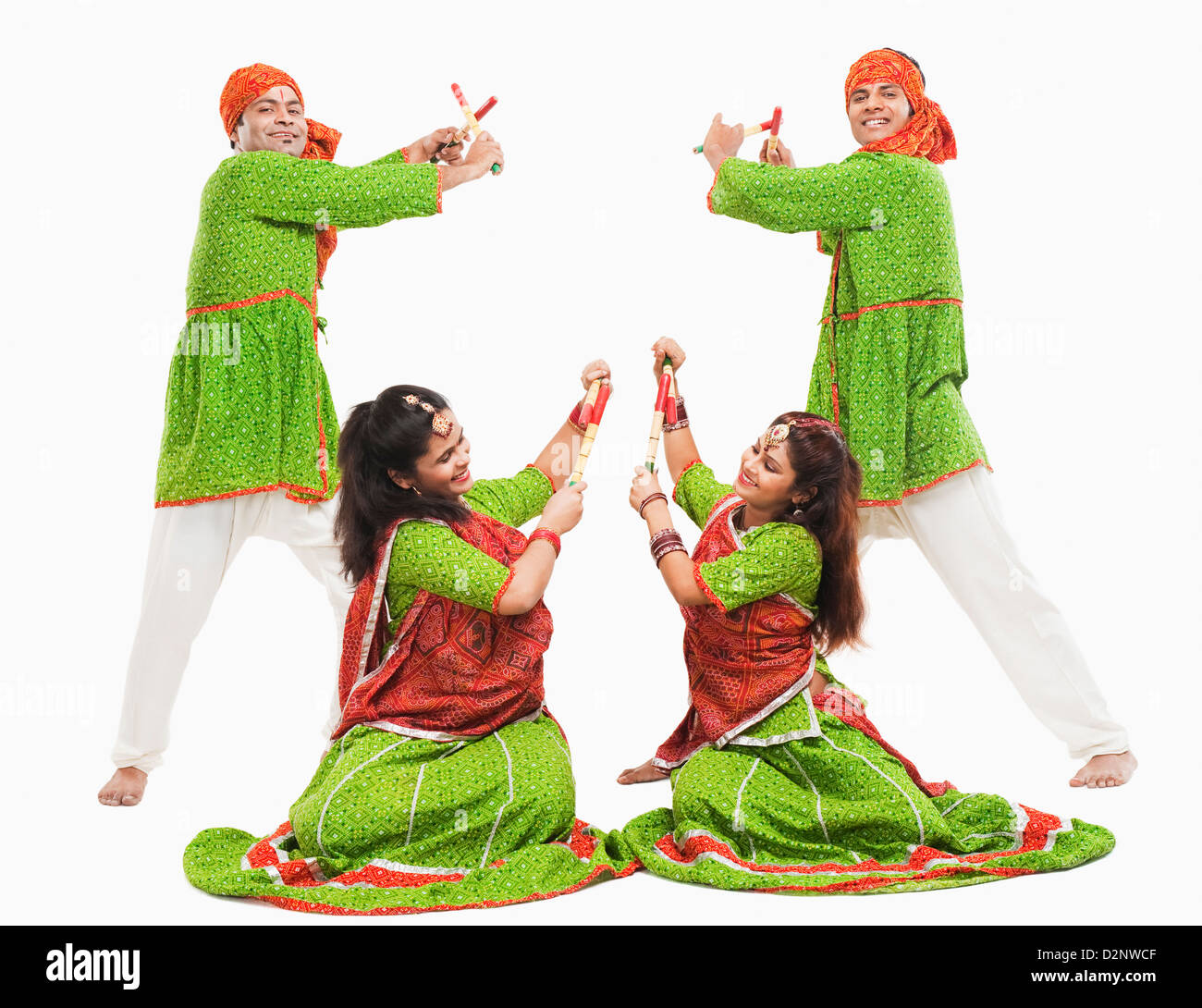 Men and women performing dandiya Stock Photo - Alamy