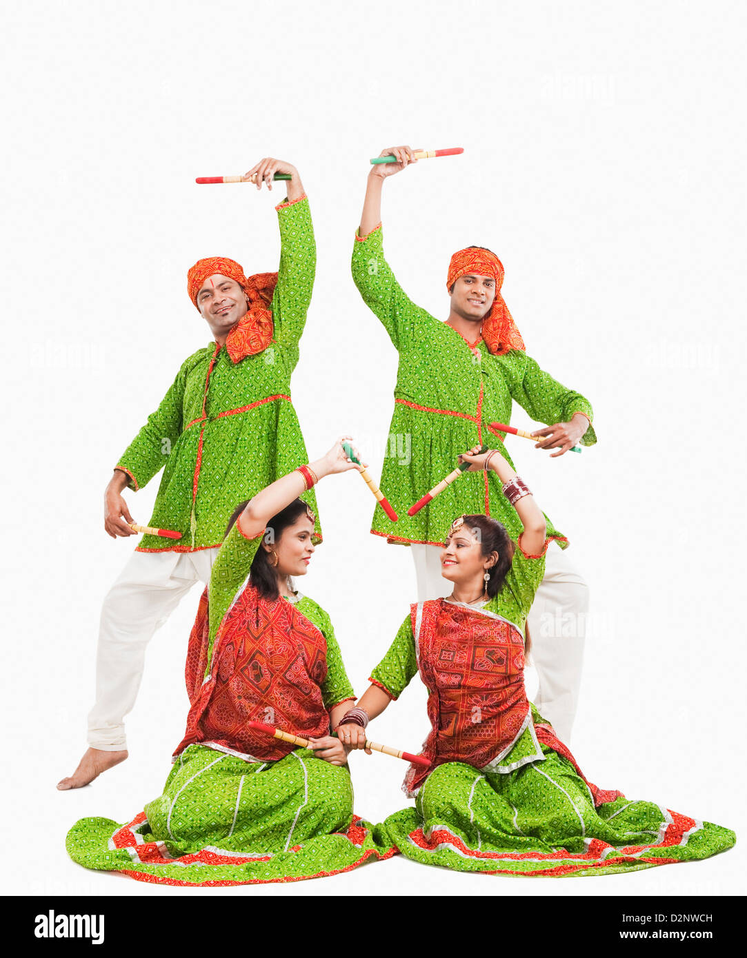 Men and women performing dandiya Stock Photo - Alamy