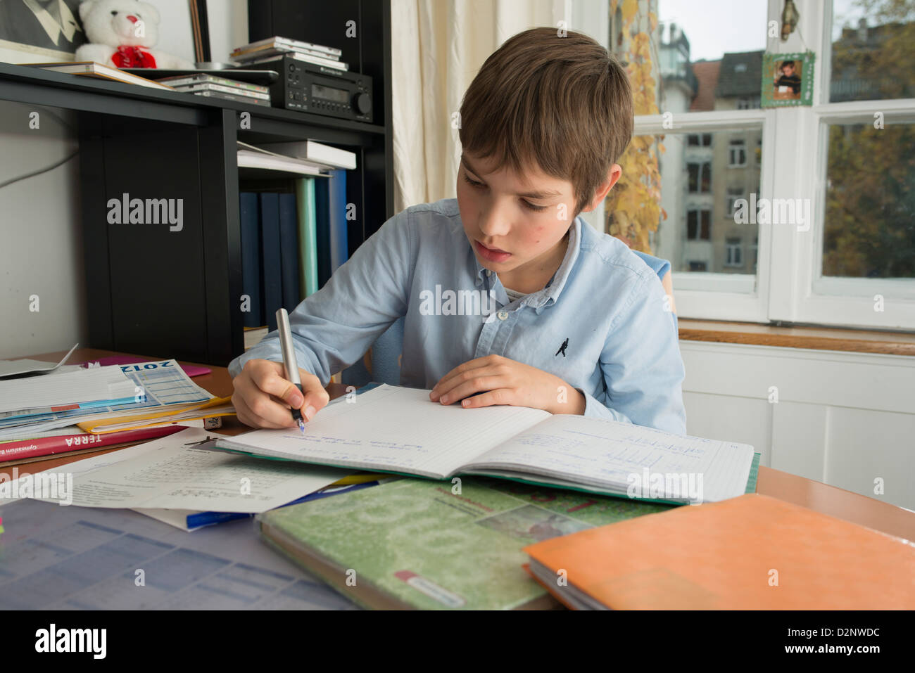 Boy works on his homework Stock Photo - Alamy