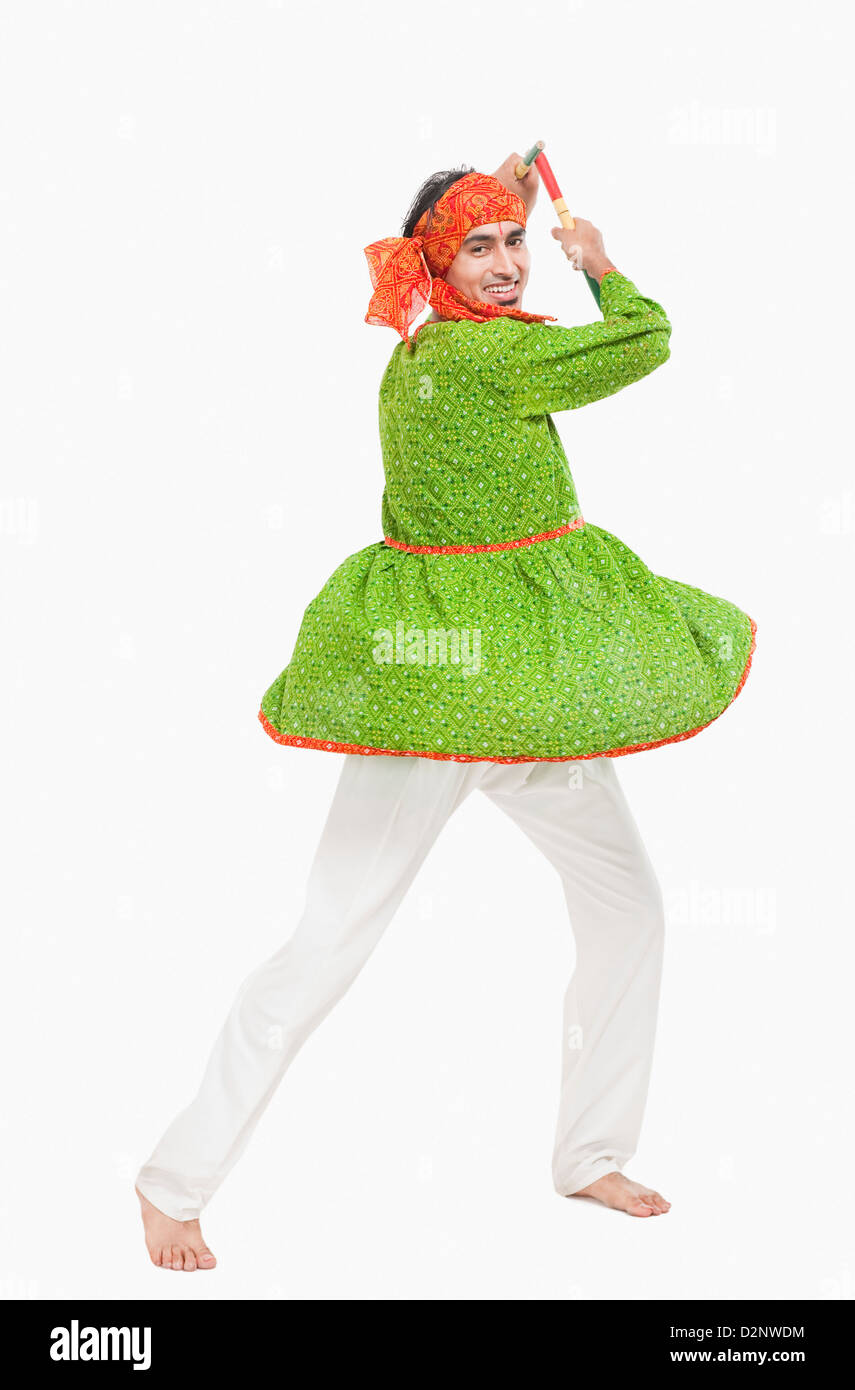 Man performing dandiya Stock Photo - Alamy