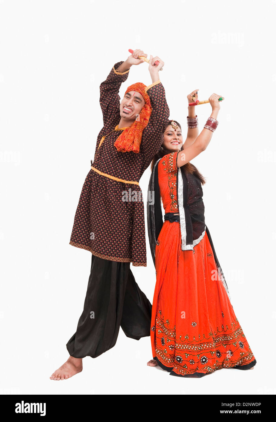 Couple performing dandiya Stock Photo - Alamy
