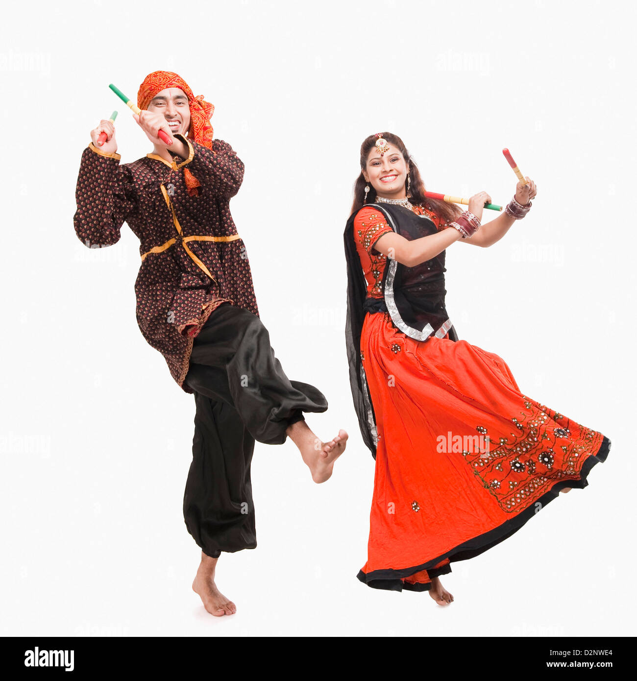 Couple performing dandiya Stock Photo - Alamy