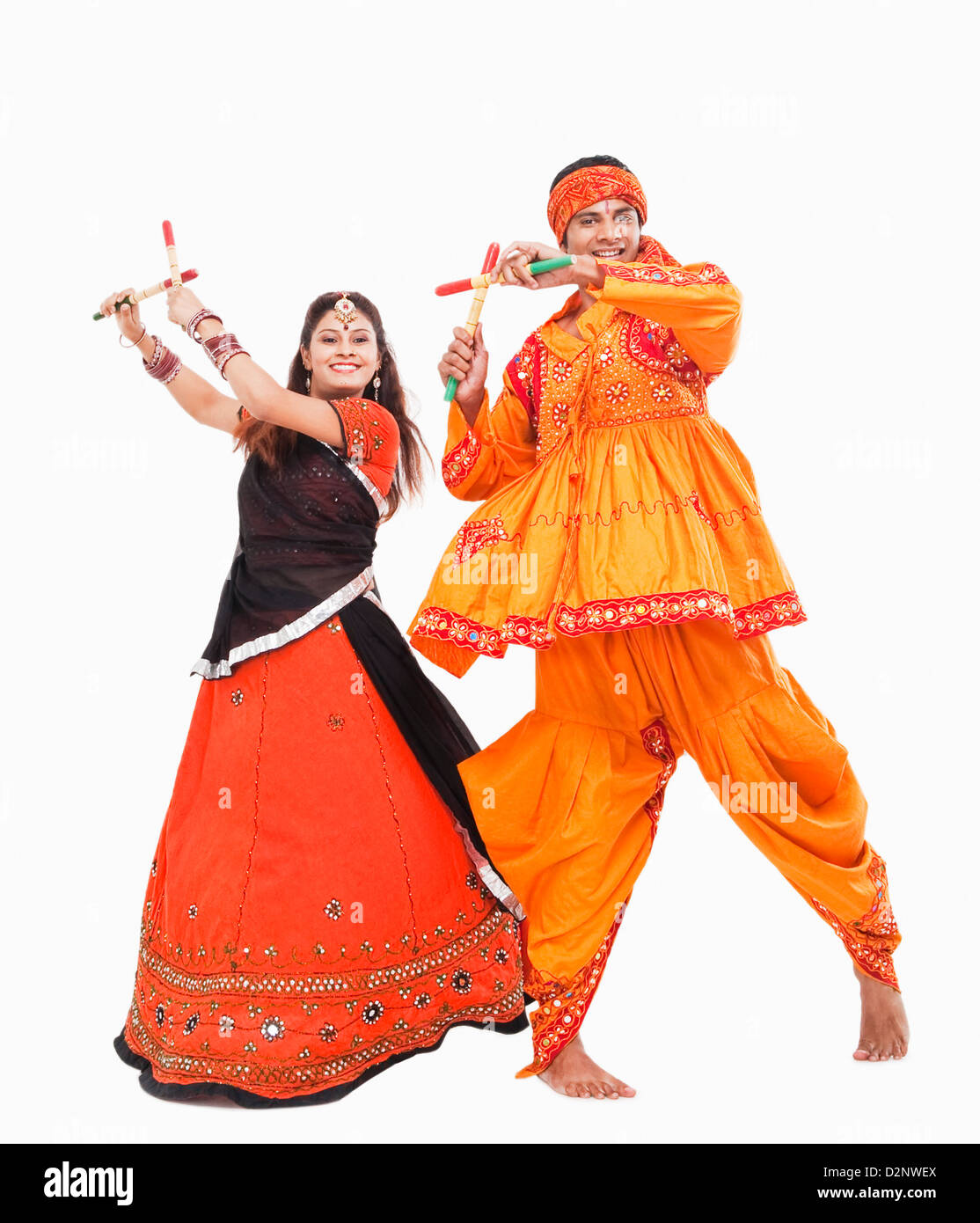 Couple performing dandiya Stock Photo - Alamy