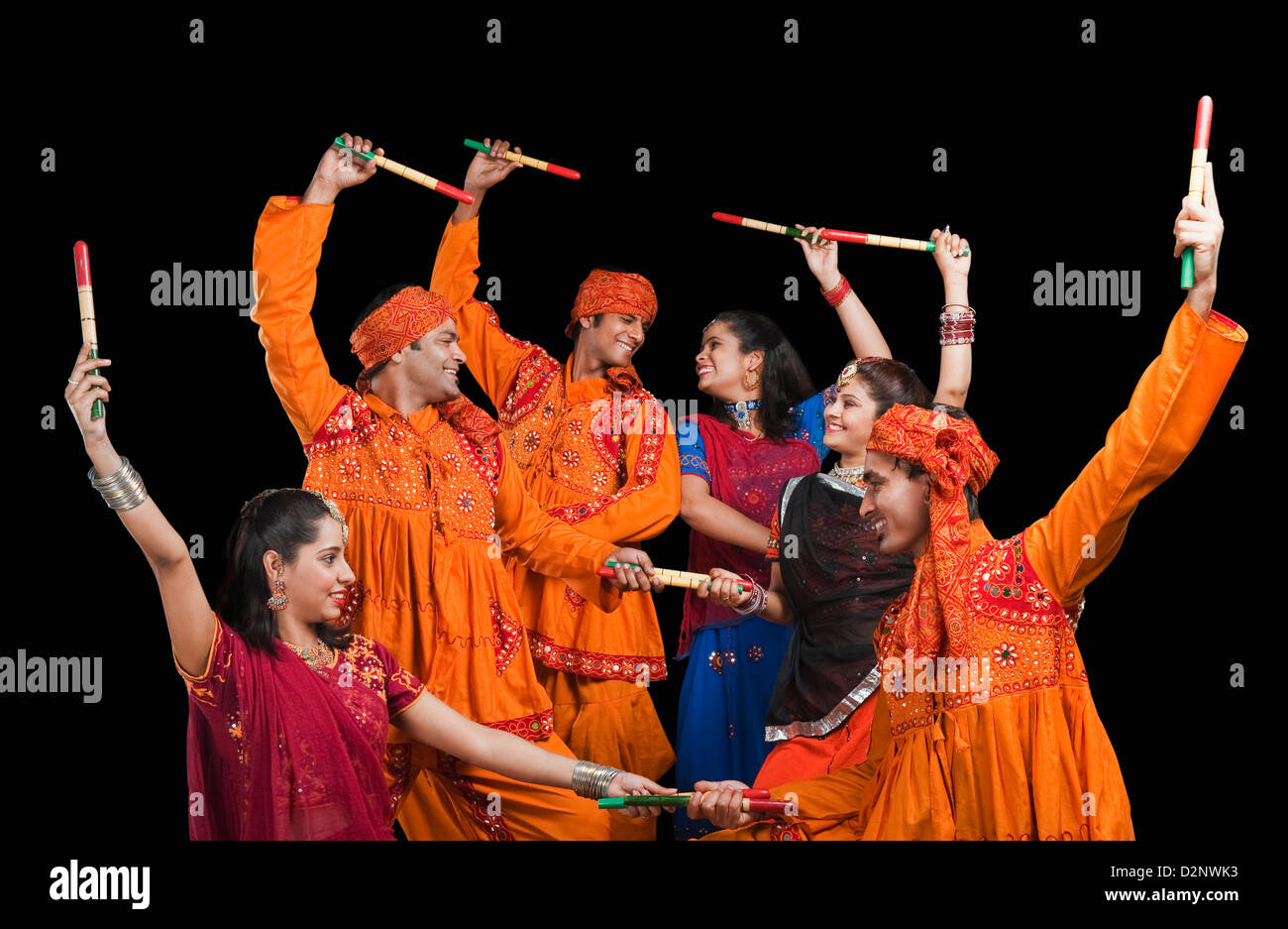 Men and women performing dandiya Stock Photo - Alamy