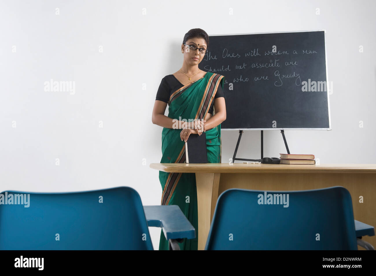Female teacher in a classroom Stock Photo - Alamy