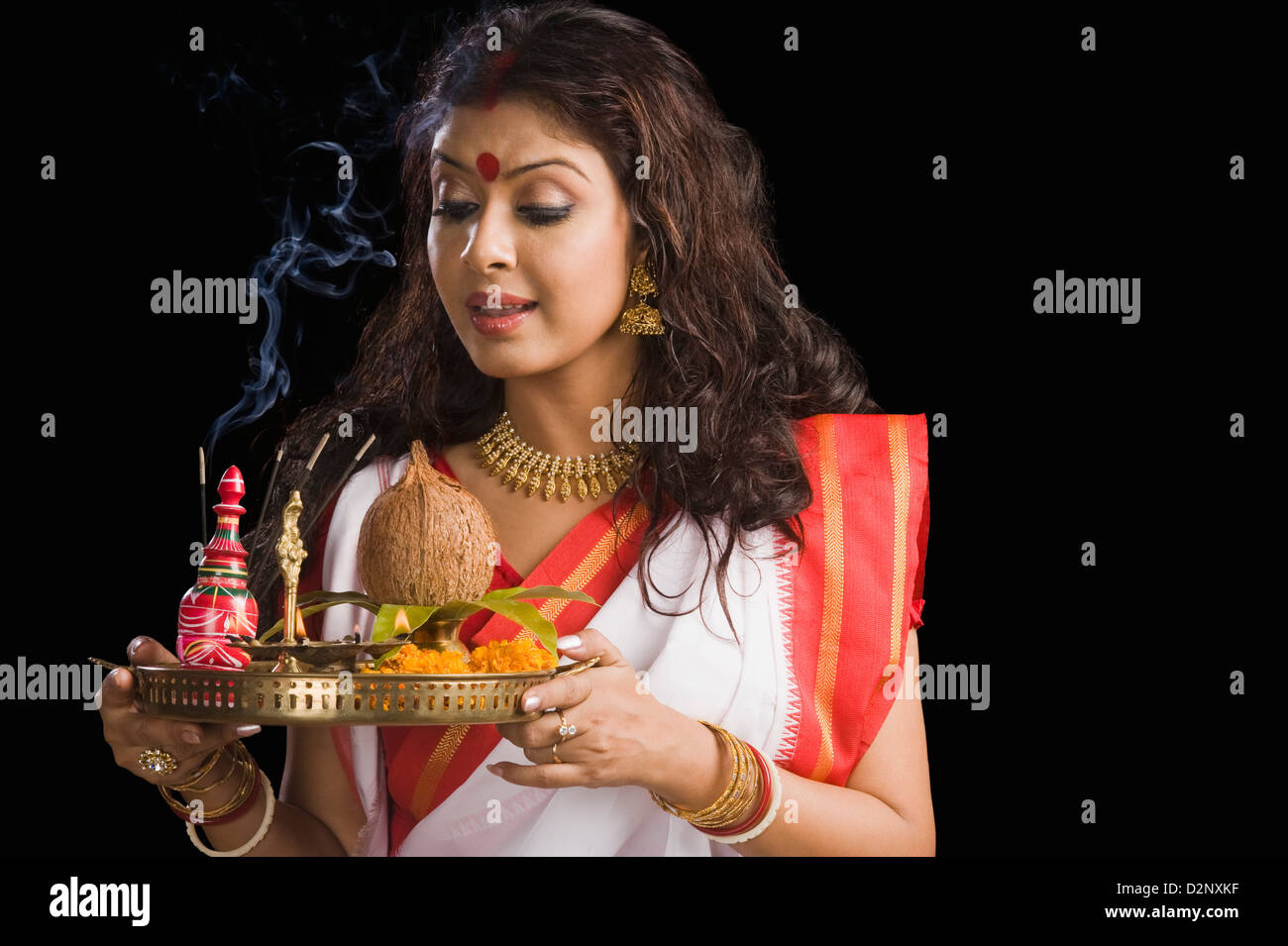 Woman holding a puja thali at Durga puja Stock Photo - Alamy