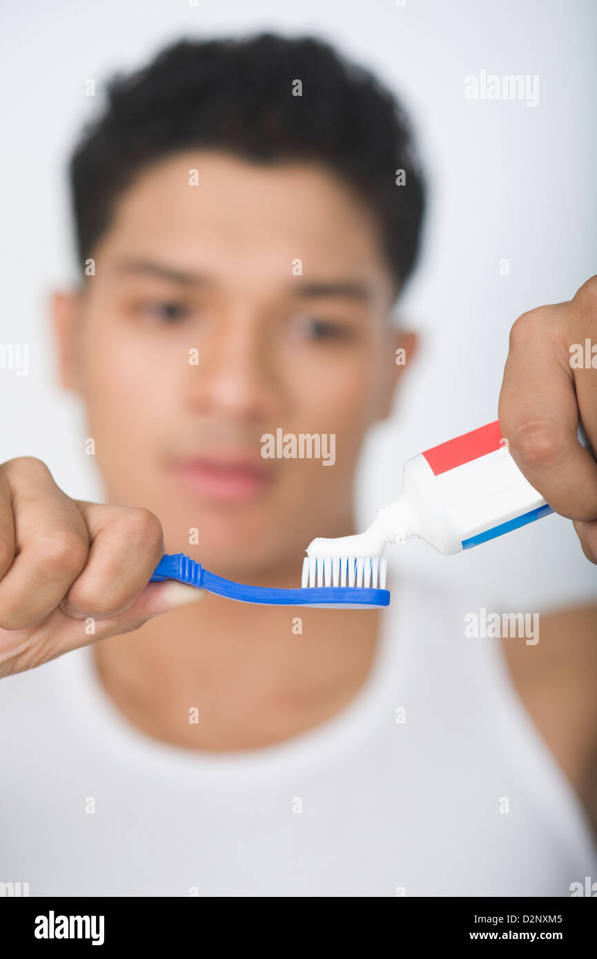 Man applying toothpaste on a toothbrush Stock Photo - Alamy
