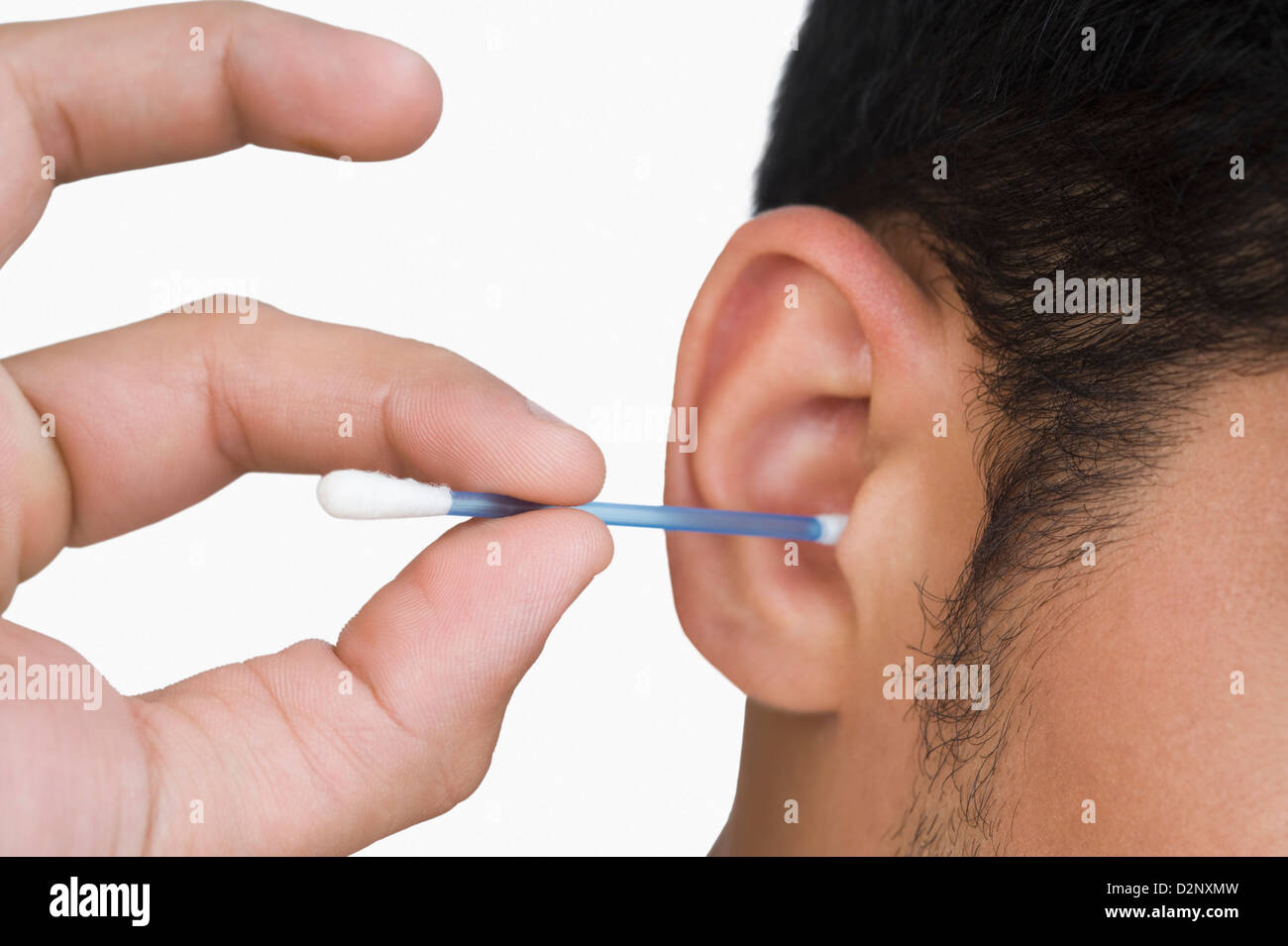 Man cleaning his ear with a cotton swab Stock Photo - Alamy