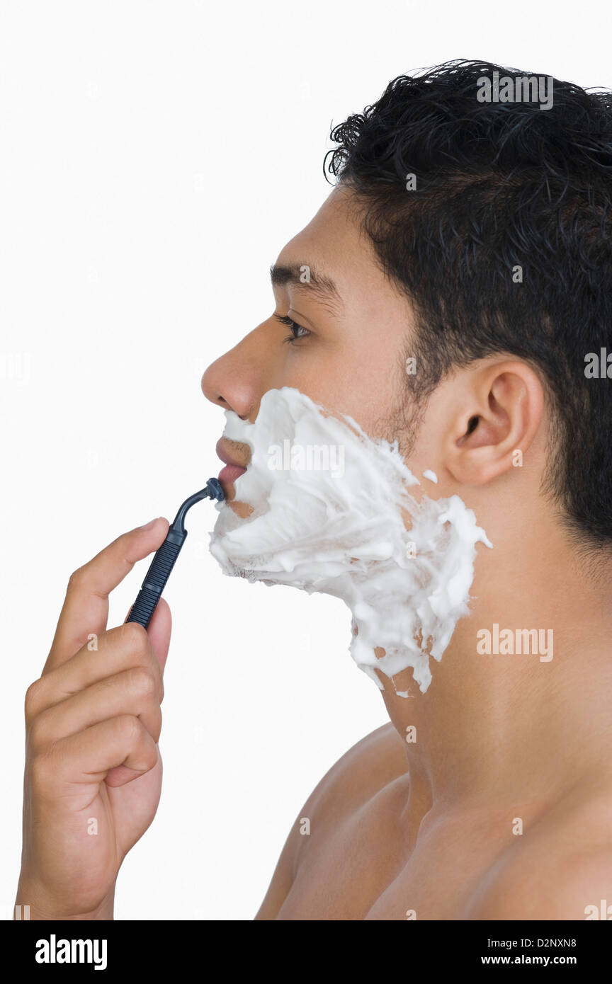 Man shaving his face Stock Photo - Alamy