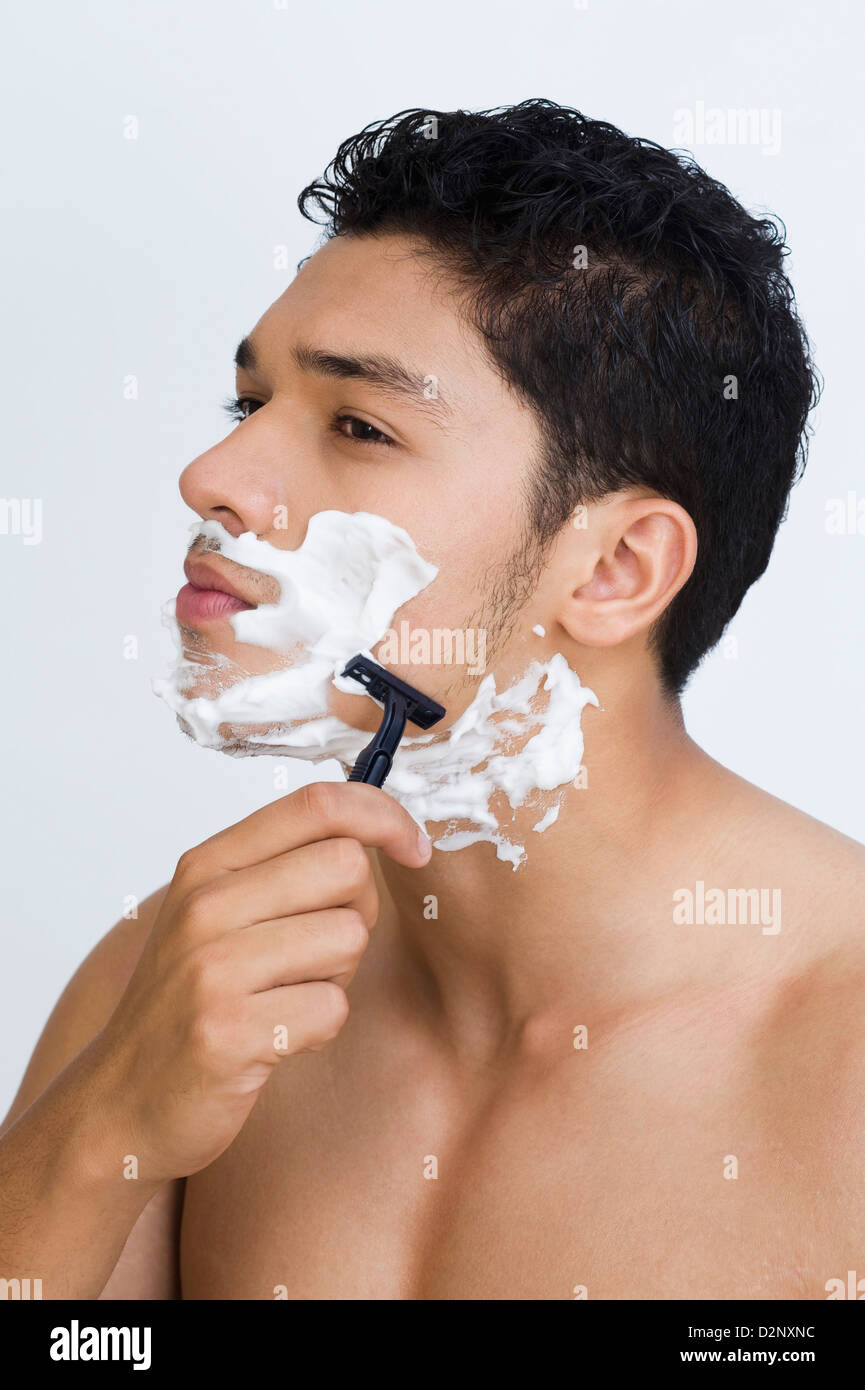 Man shaving his face Stock Photo - Alamy