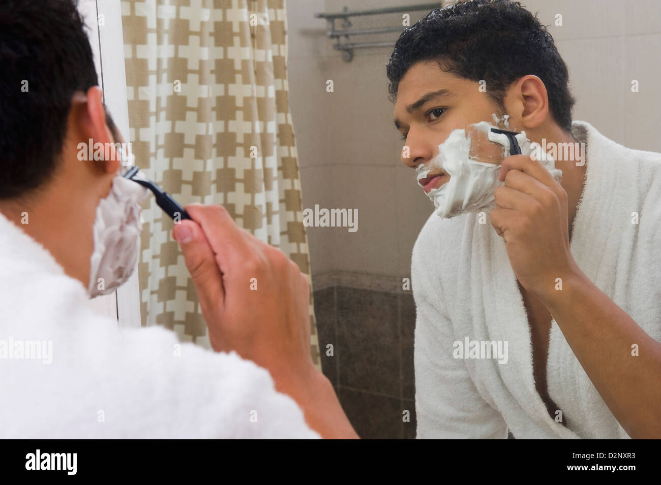 Man shaving his face in the bathroom Stock Photo - Alamy