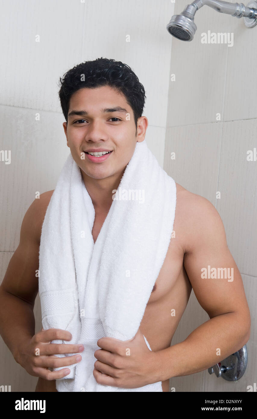 Portrait of a man with a towel in a bathroom Stock Photo - Alamy