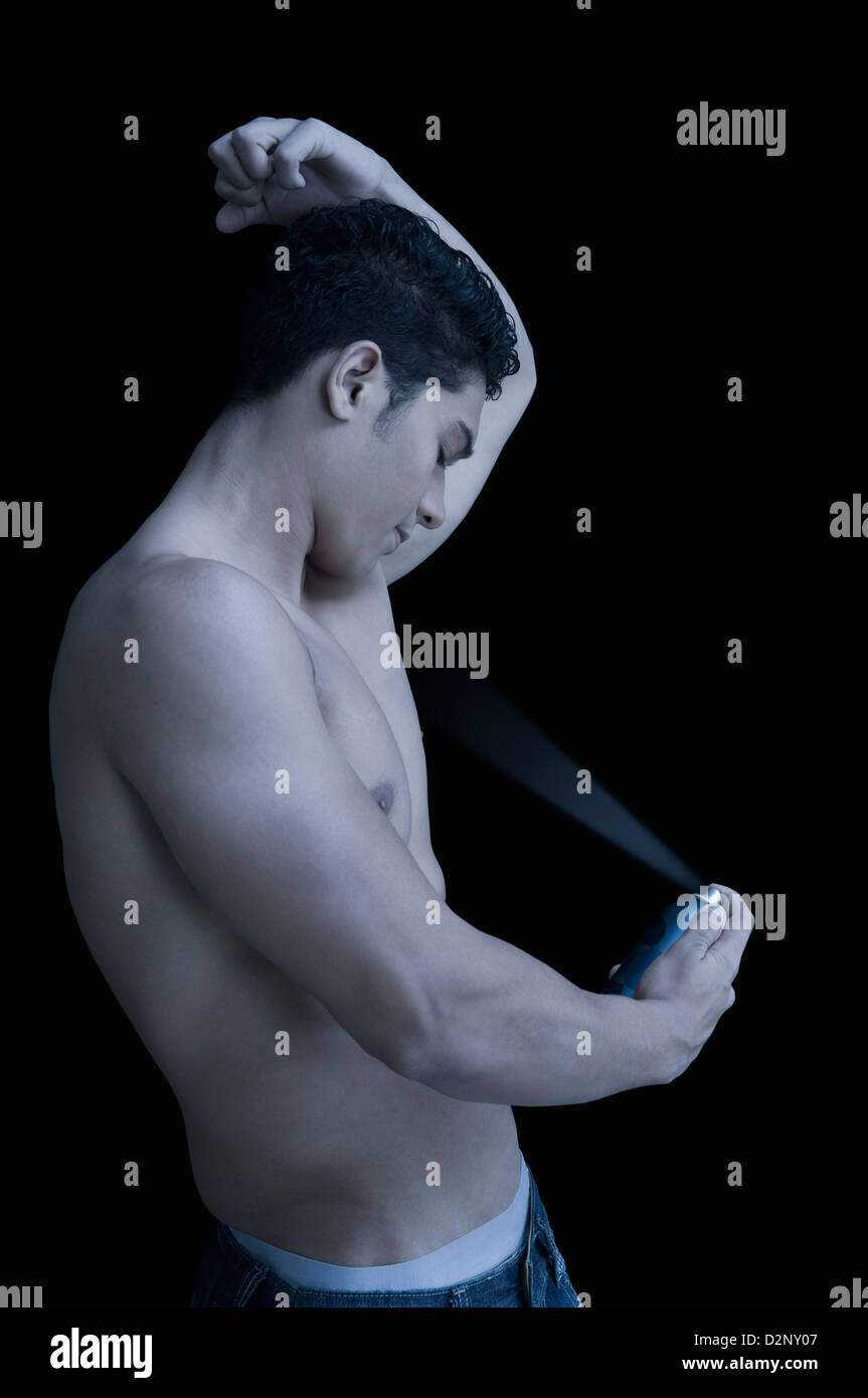 Man applying deodorant Stock Photo - Alamy
