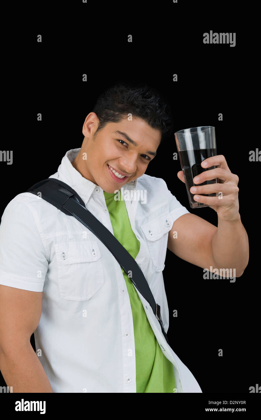 Man holding a glass of cola and smiling Stock Photo - Alamy
