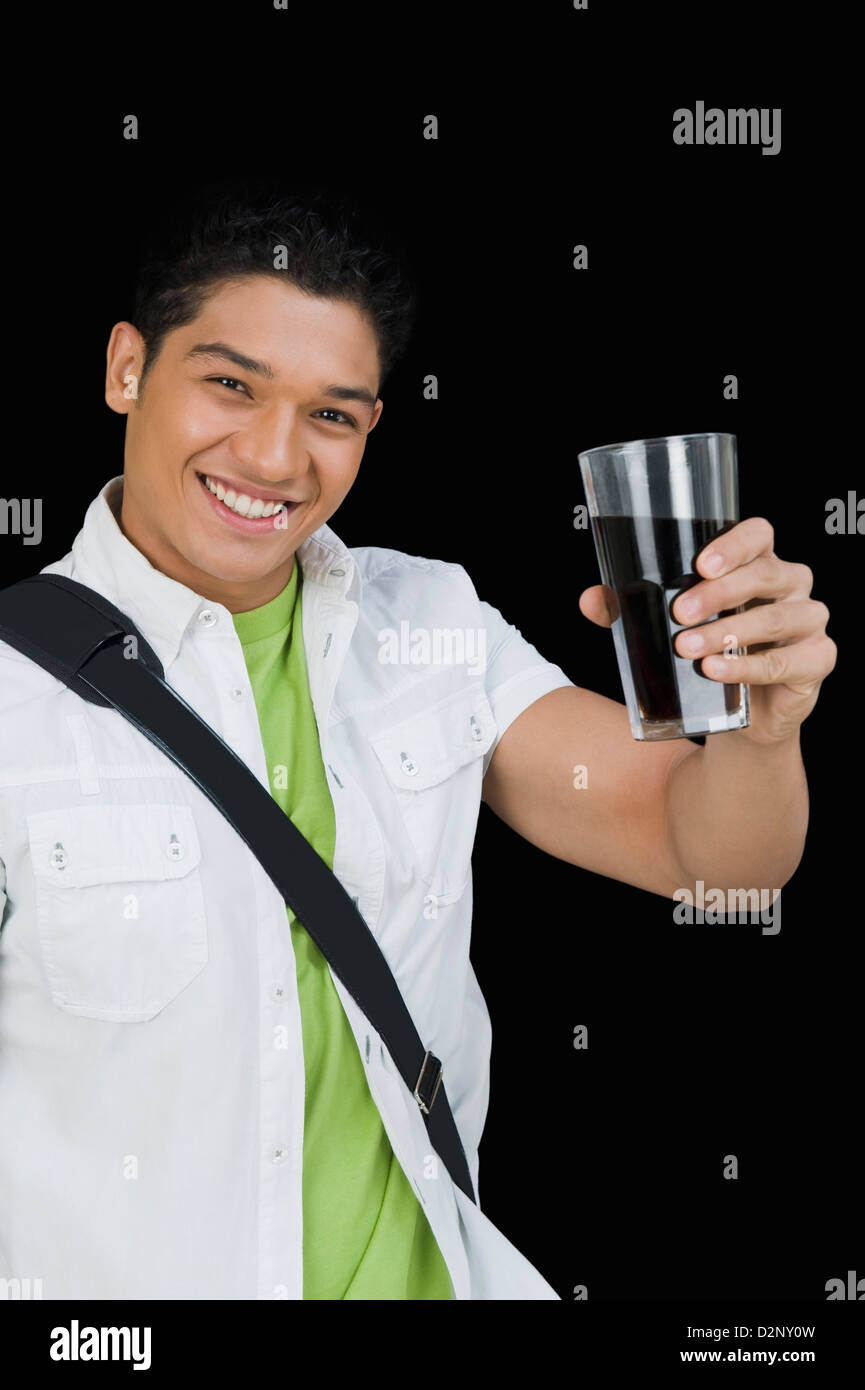 Man holding a glass of cola and smiling Stock Photo - Alamy