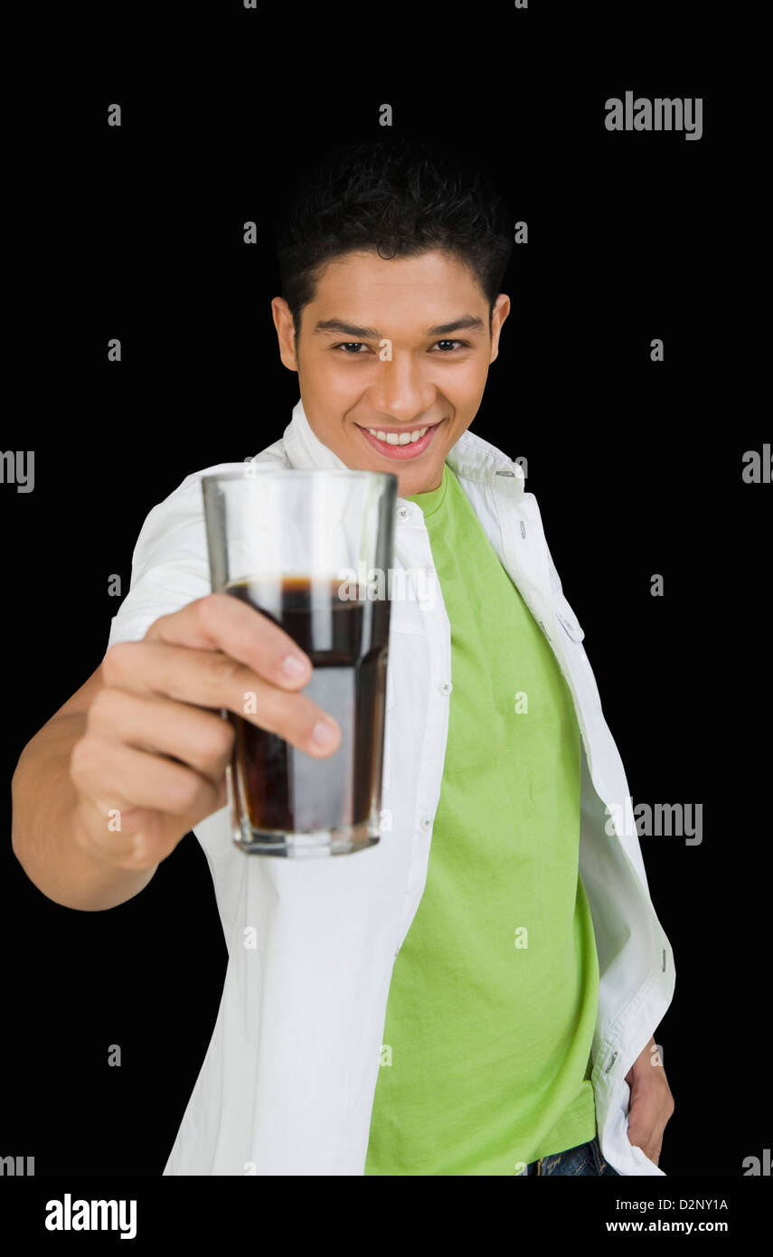 Man holding a glass of cola and smiling Stock Photo - Alamy