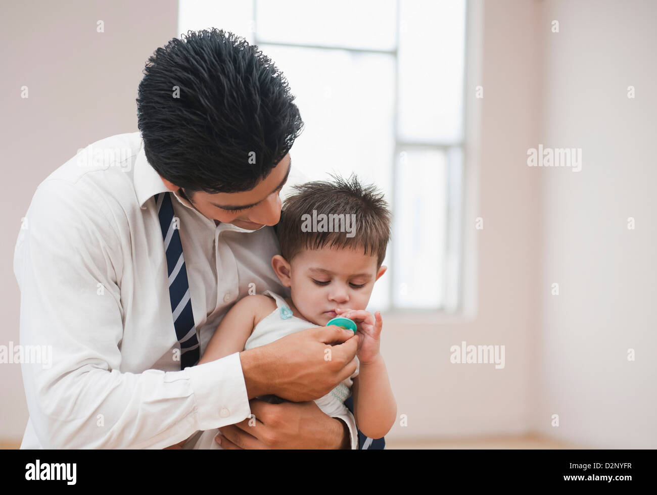 Man giving pacifier to his daughter Stock Photo - Alamy