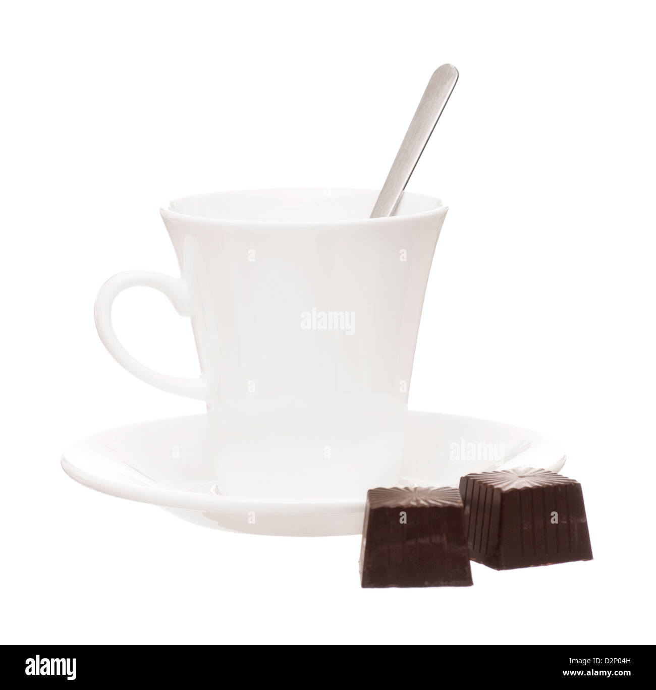 Small white cup with saucer and chocolate isolated on white background ...